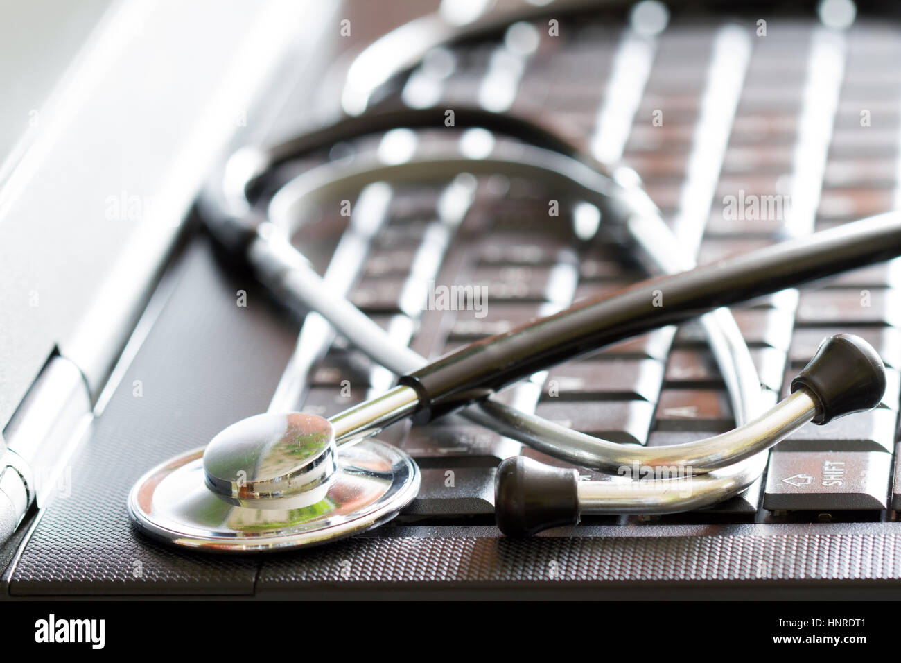 Stethoscope on black laptop computer medical technology concept with ...