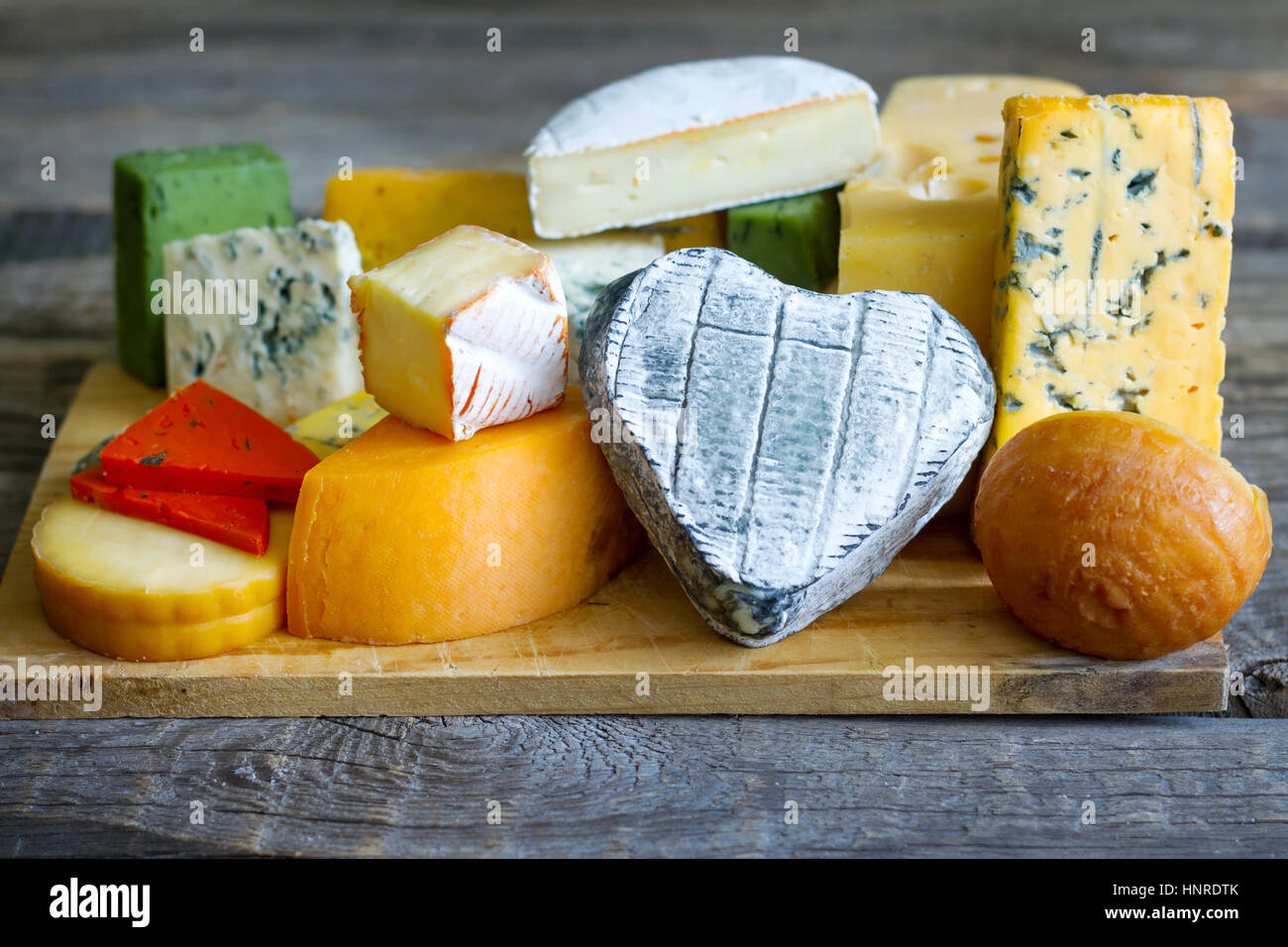 Heart shaped cheese on old boards colorful food abstract still life ...