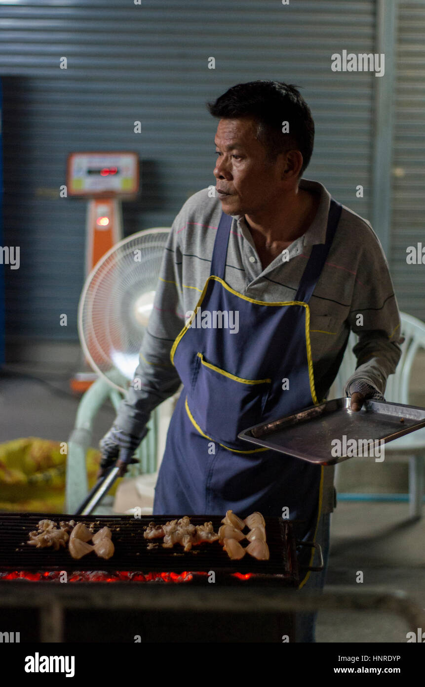 Chef preparing seafood at a street restaurant on the street in ...