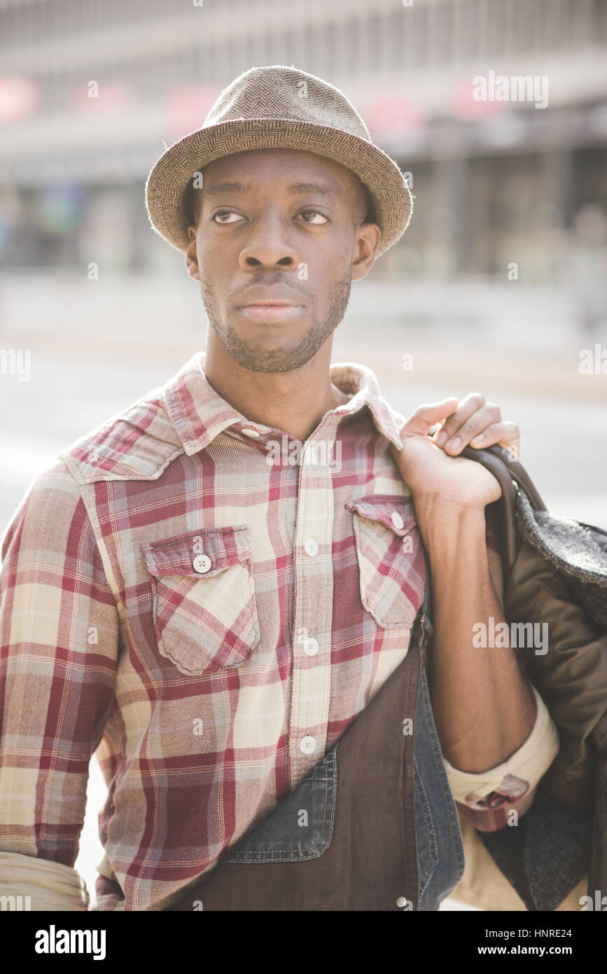 Portrait of young beautiful afro black man outdoor overlooking serious ...