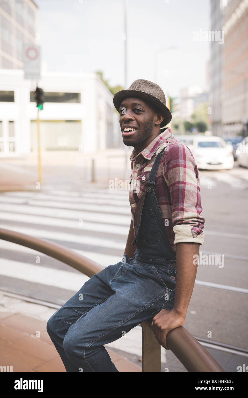 Young handsome afro black man outdoor in the city smiling - happiness ...