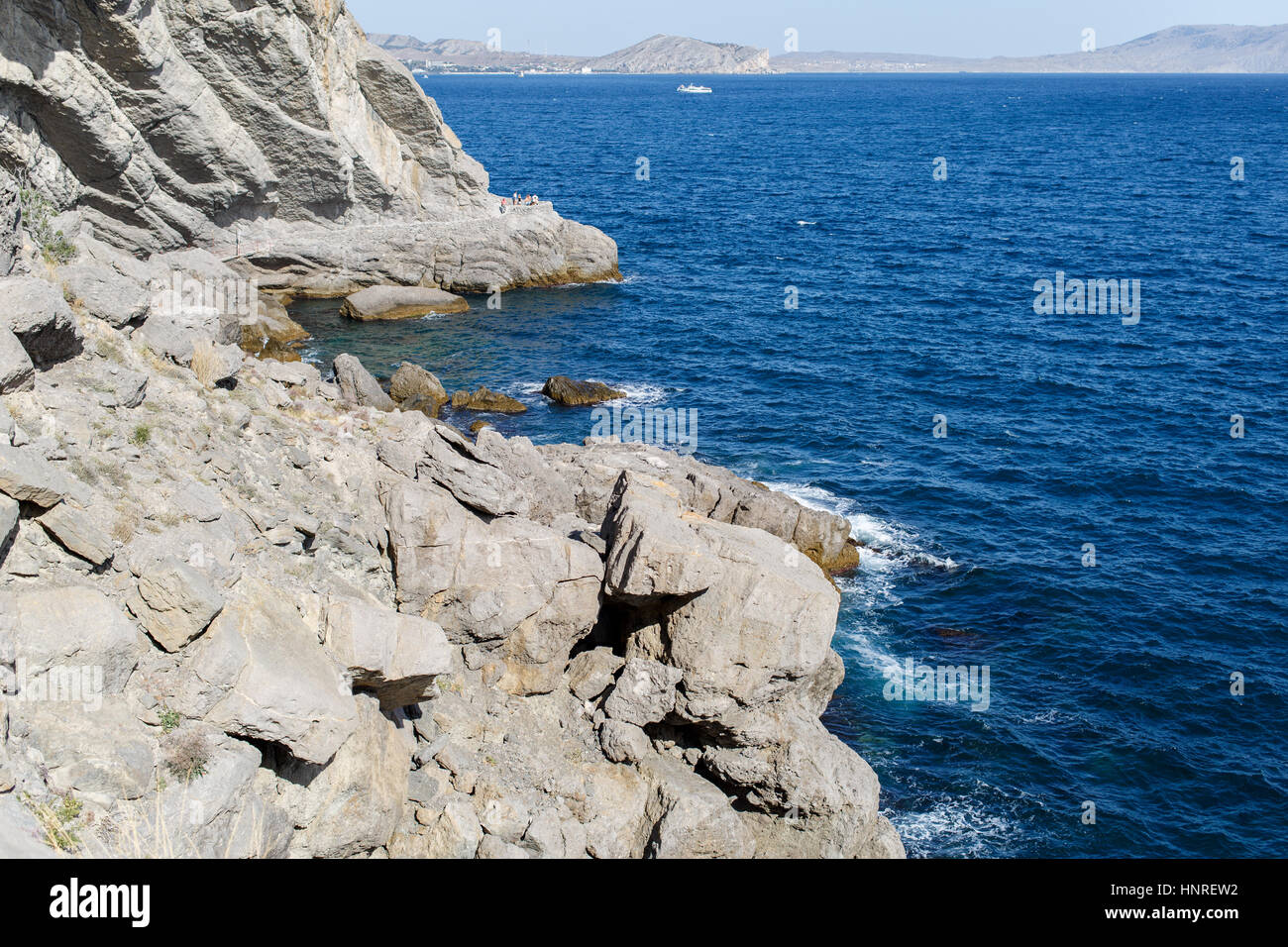 Sea shore at foot of mountain slope Stock Photo - Alamy