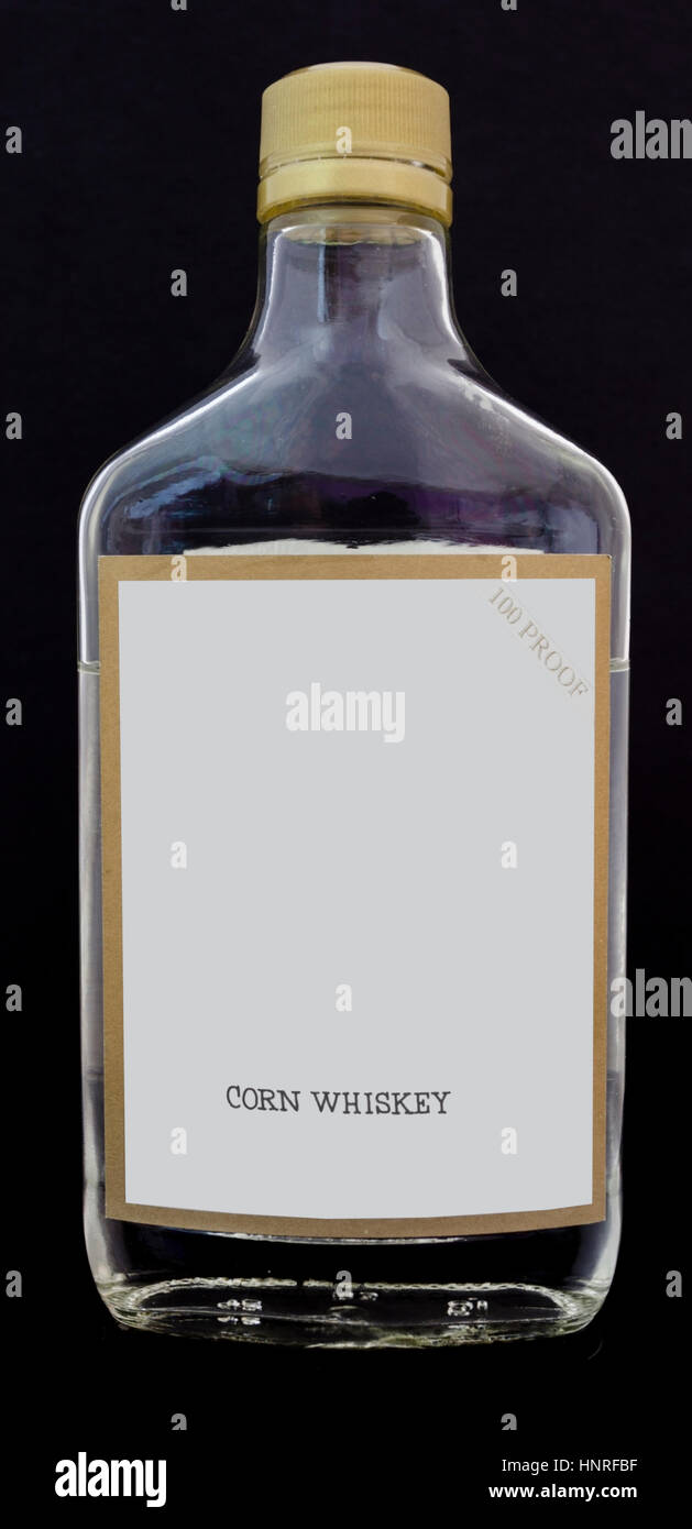 Corn whiskey bottle with blank label against black background. Copy ...
