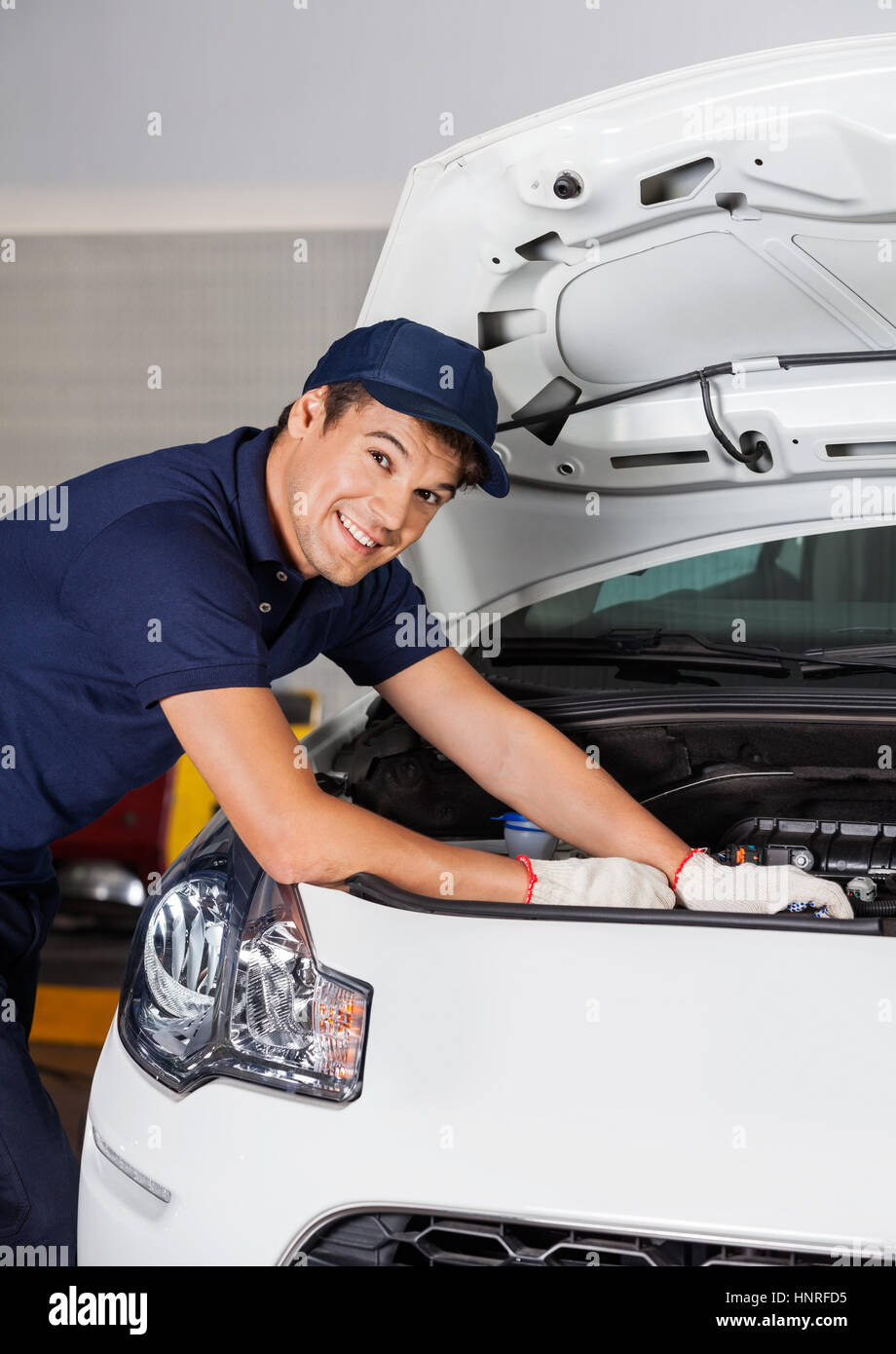 Mechanic Examining Car Engine At Garage Stock Photo - Alamy
