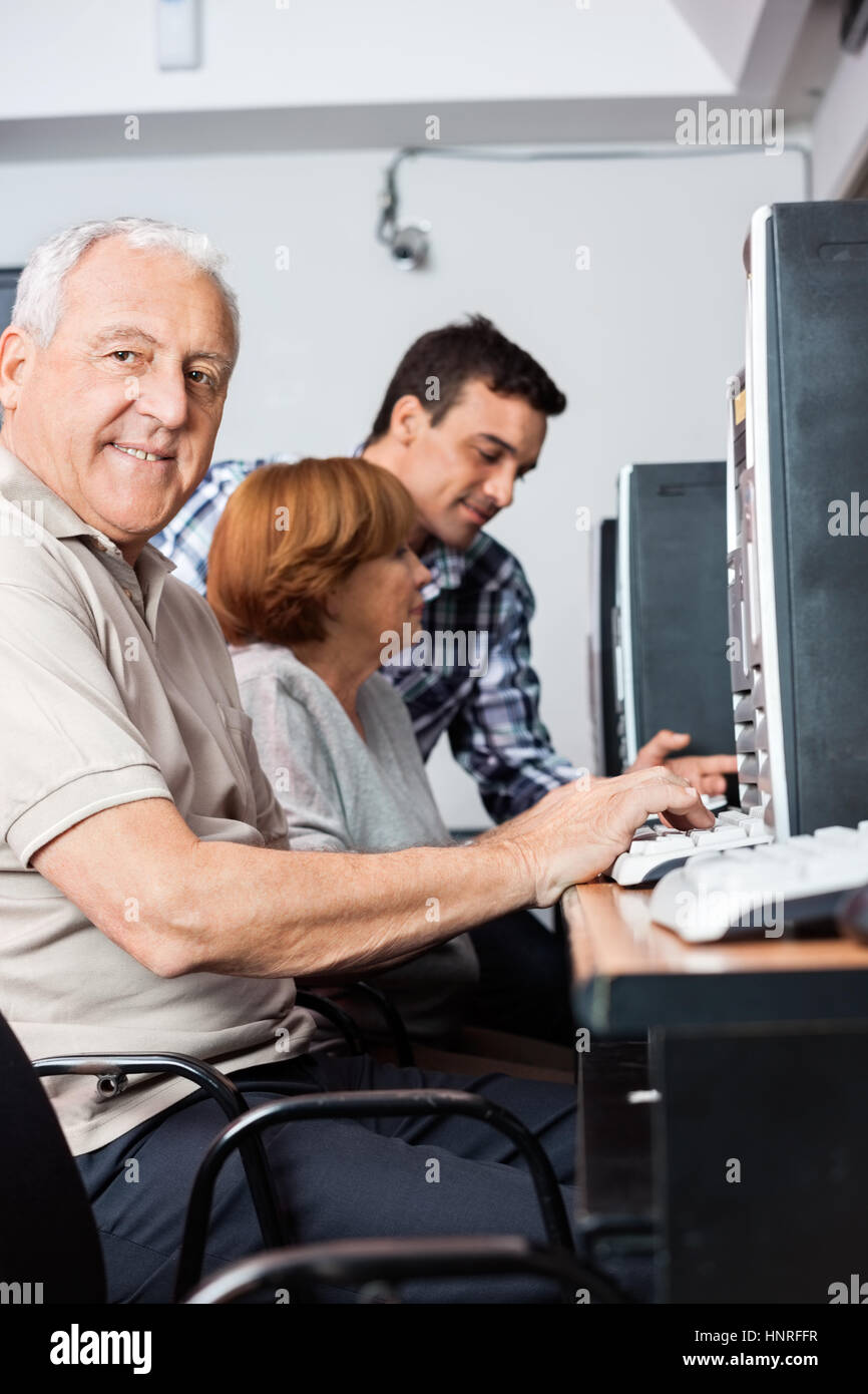 Portrait Of Senior Man Using Computer In Classroom Stock Photo - Alamy