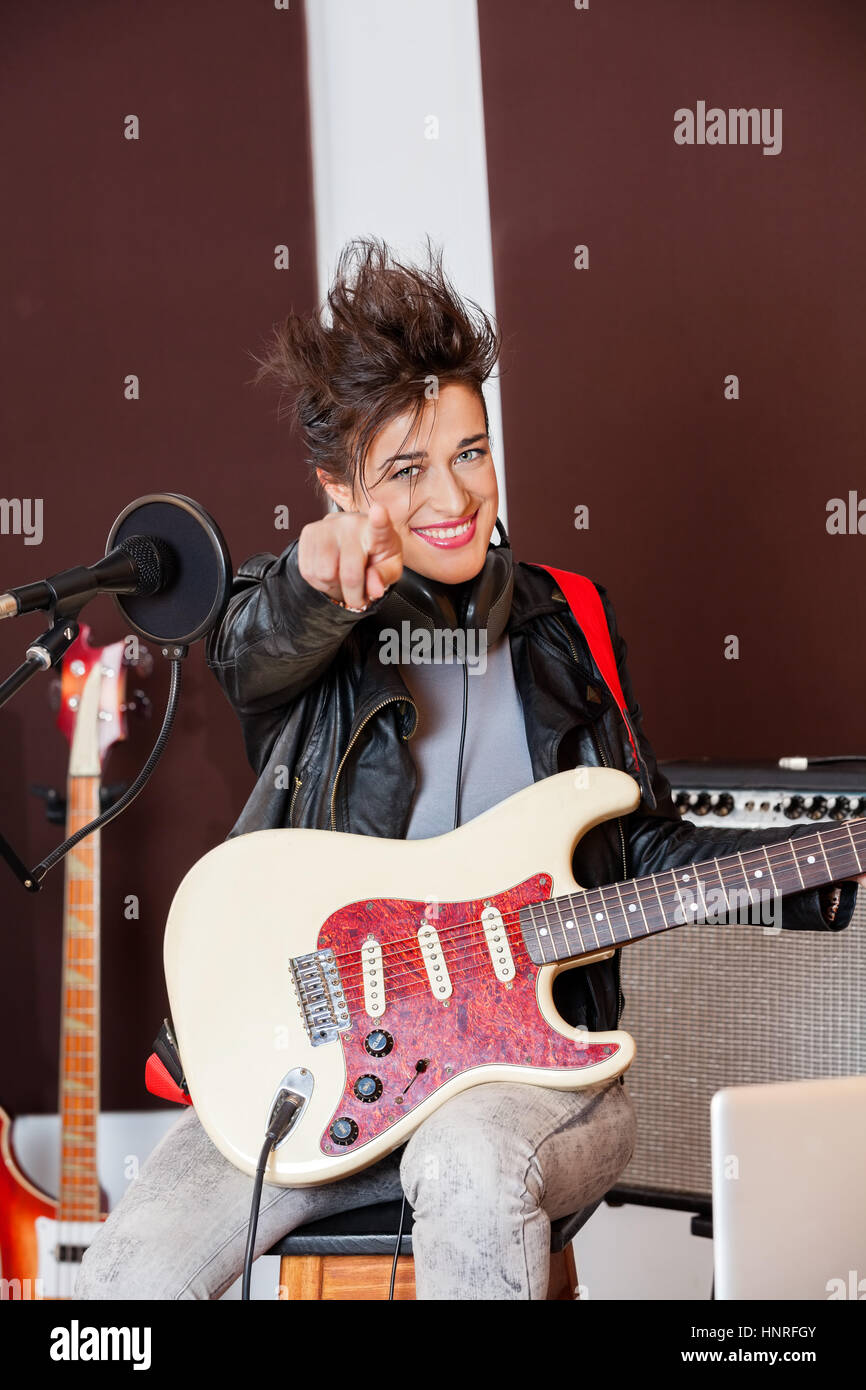 Female singer pointing to microphone hi-res stock photography and ...