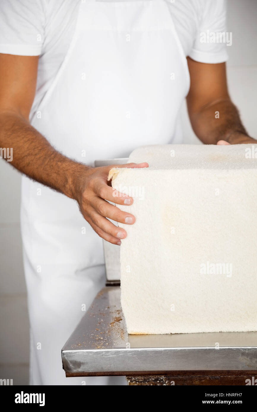Midsection Of Baker With Bread Loaf In Bakery Stock Photo - Alamy