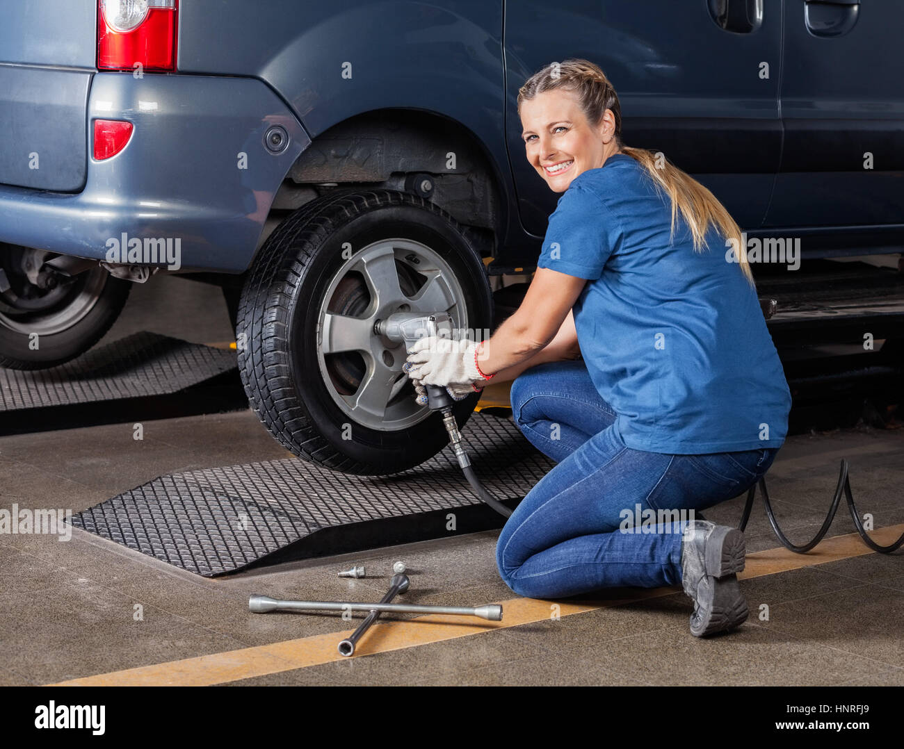 Mechanic fixing tire hi-res stock photography and images - Alamy