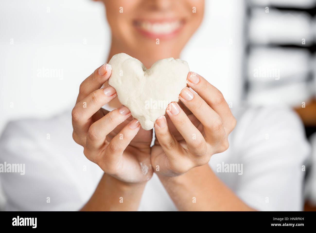 Midsection Of Baker Holding Heart Shape Dough Stock Photo - Alamy