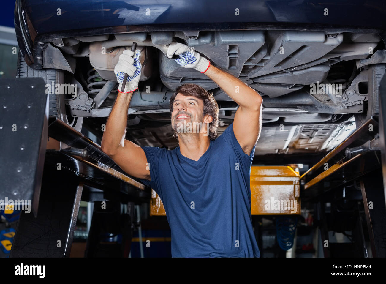 Mechanic Repairing Underneath Car Stock Photo - Alamy