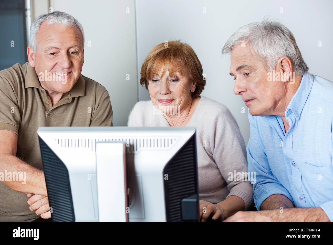 Happy Senior People Using Computer In Classroom Stock Photo - Alamy