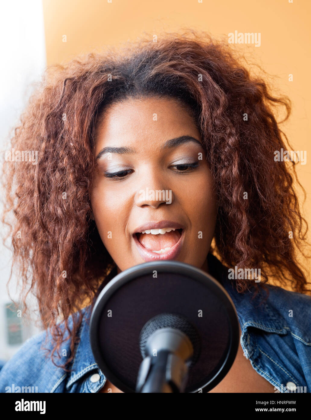 Young Woman Singing In Recording Studio Stock Photo - Alamy