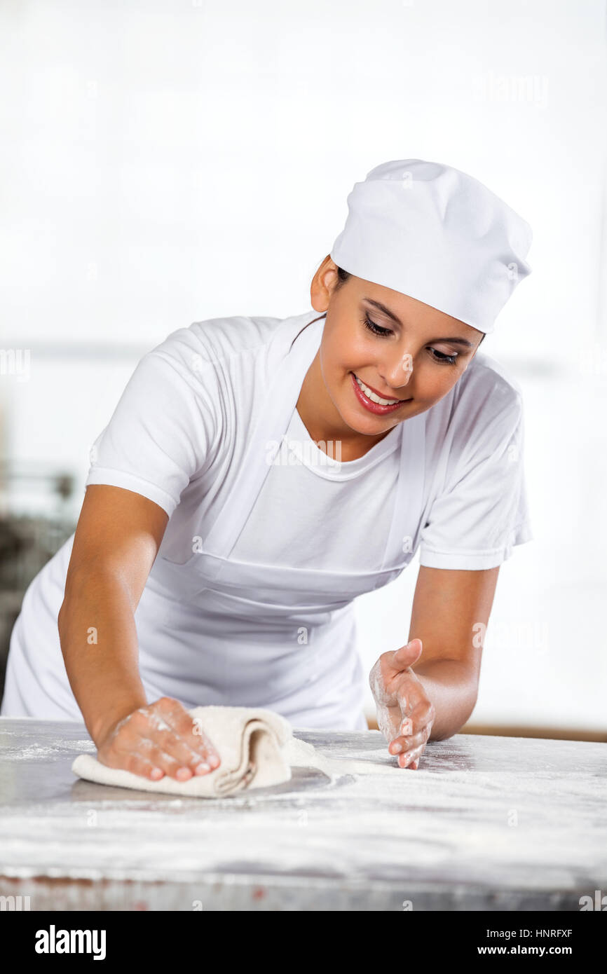 Female Baker Cleaning Table In Bakery Stock Photo - Alamy
