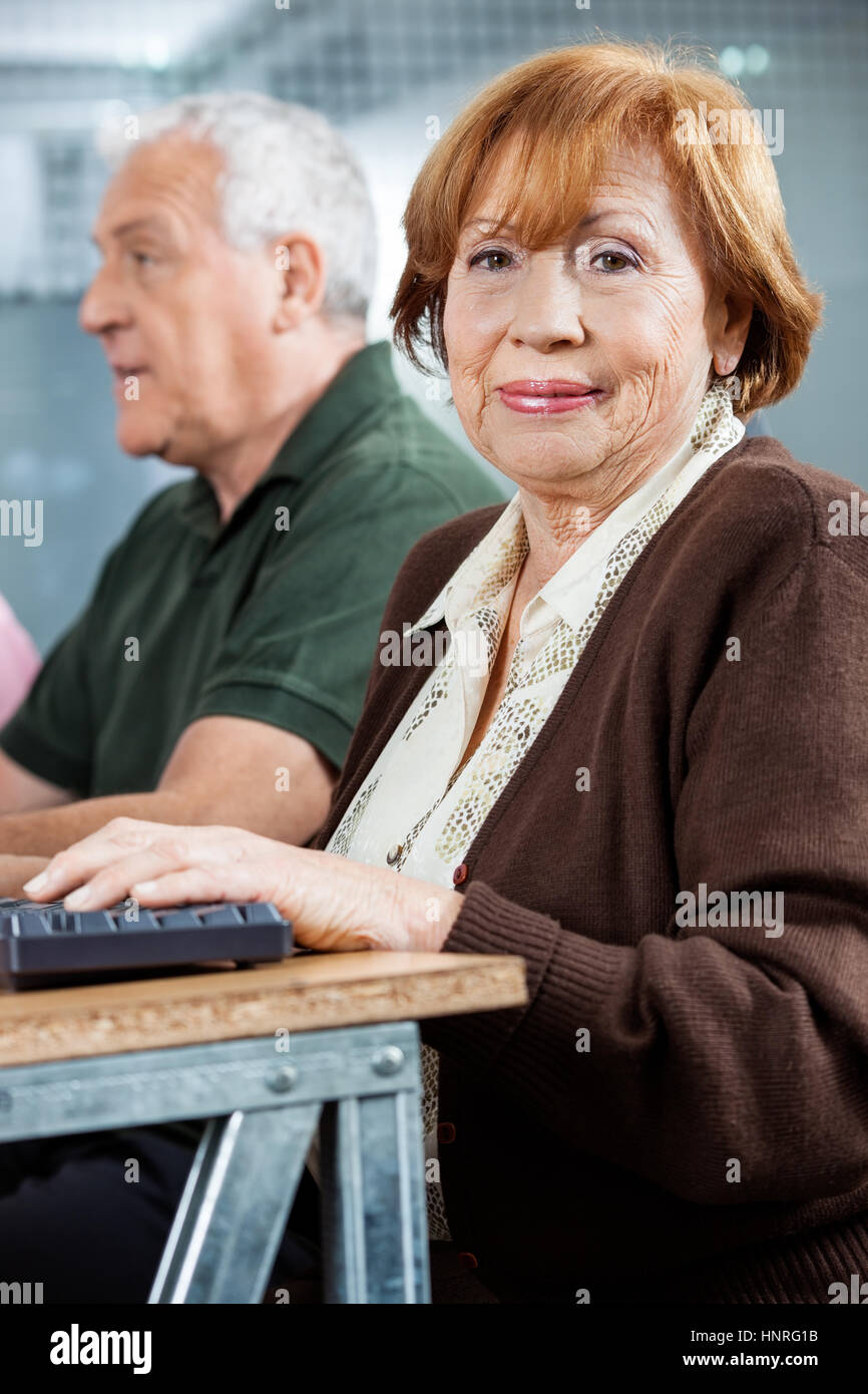 Confident Senior Student Sitting In Computer Class Stock Photo - Alamy