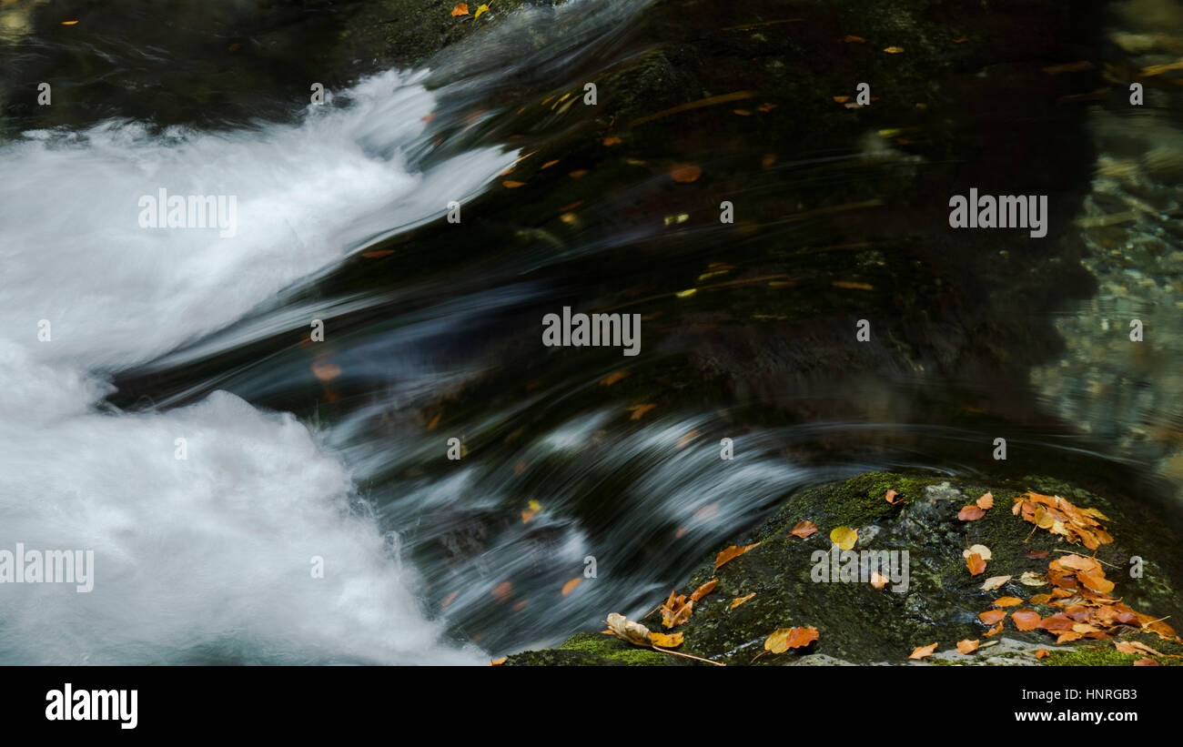 Pure mountain stream flowing over the rocks Stock Photo - Alamy