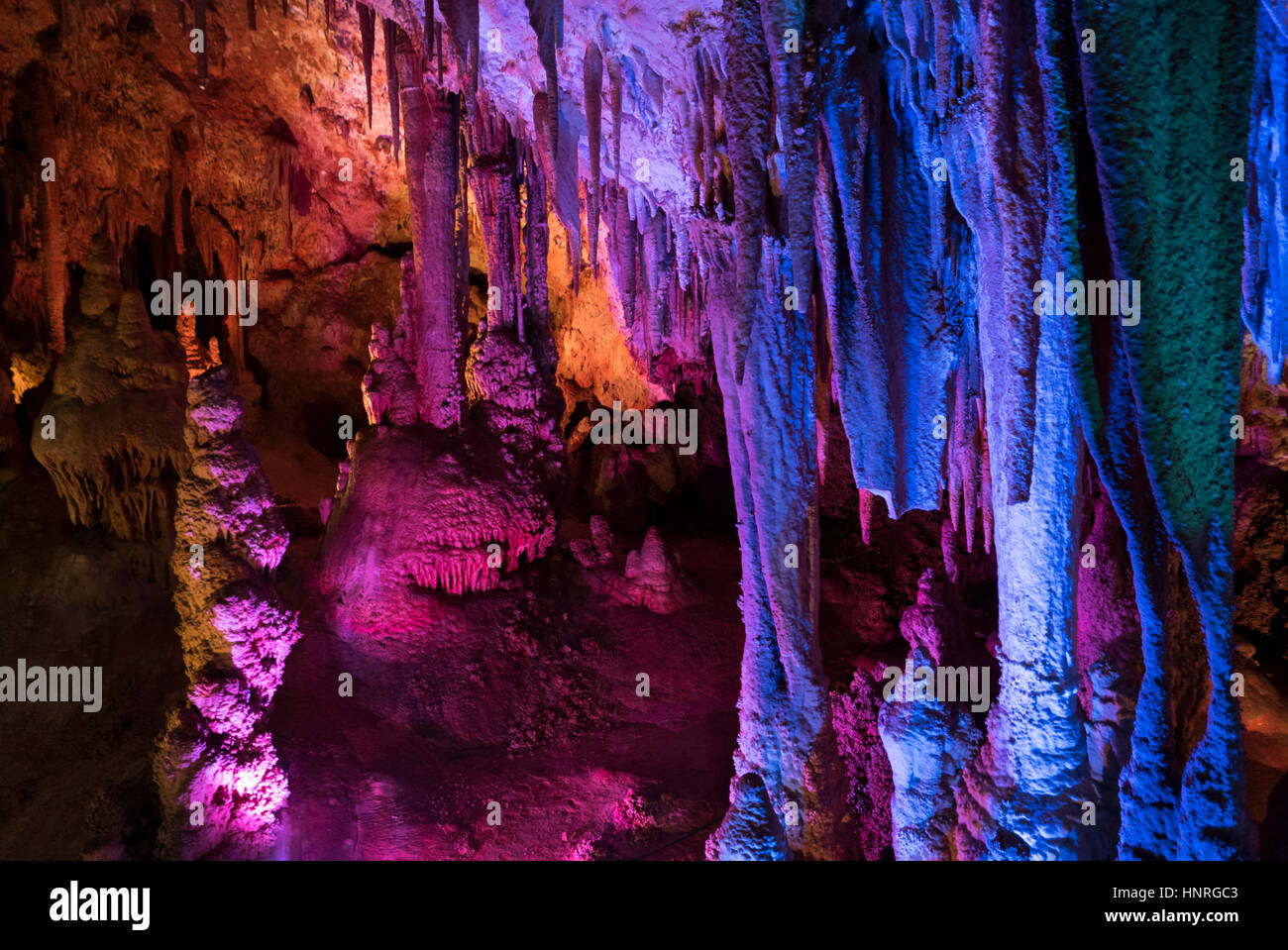 Brightly lit with colorful lights geological shapes inside a cave Stock ...