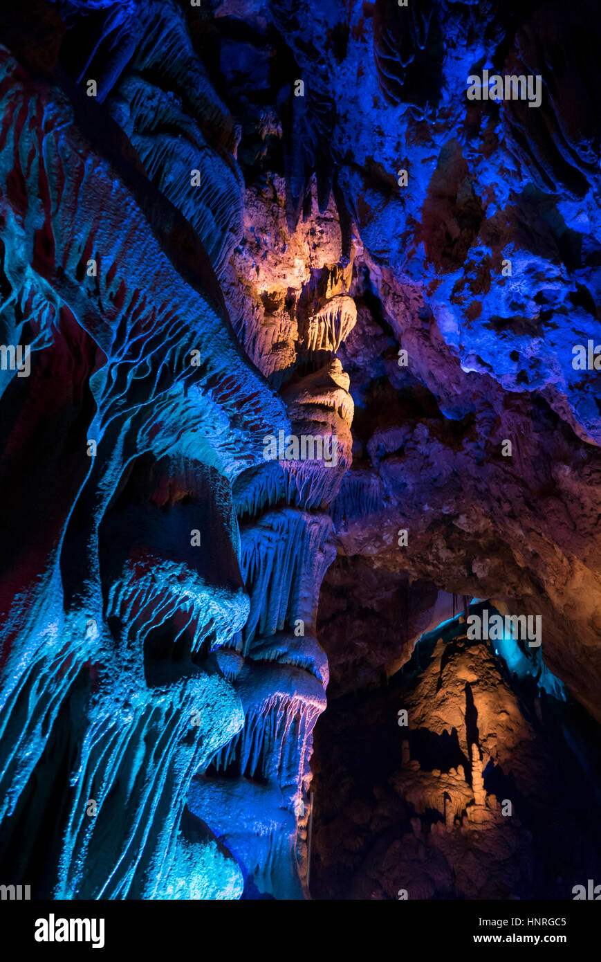 Brightly lit with colorful lights geological shapes inside a cave Stock ...