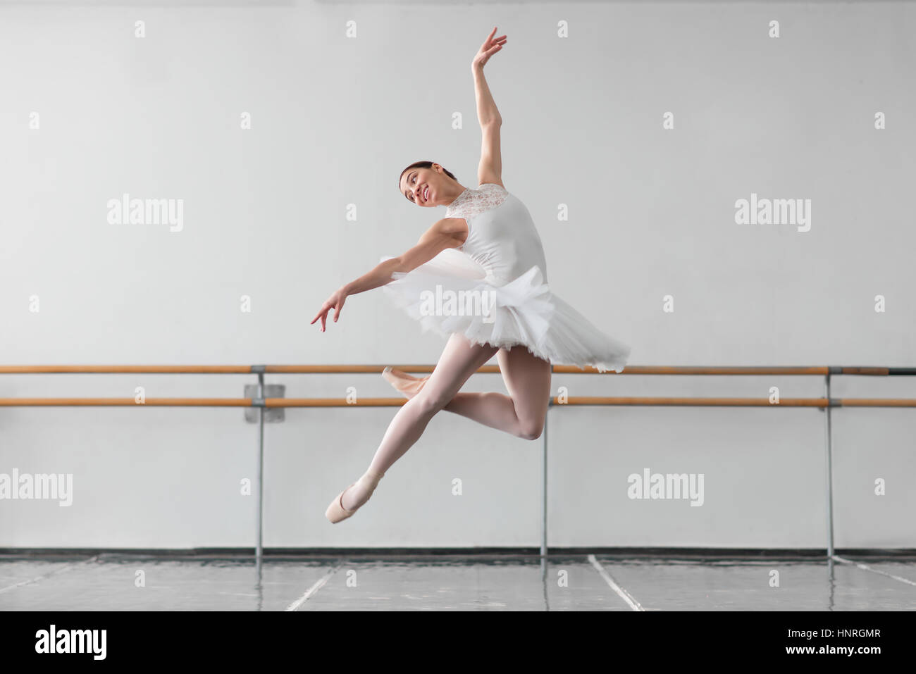 Beautiful female ballet dancer keep the rack in ballet class, barre and ...