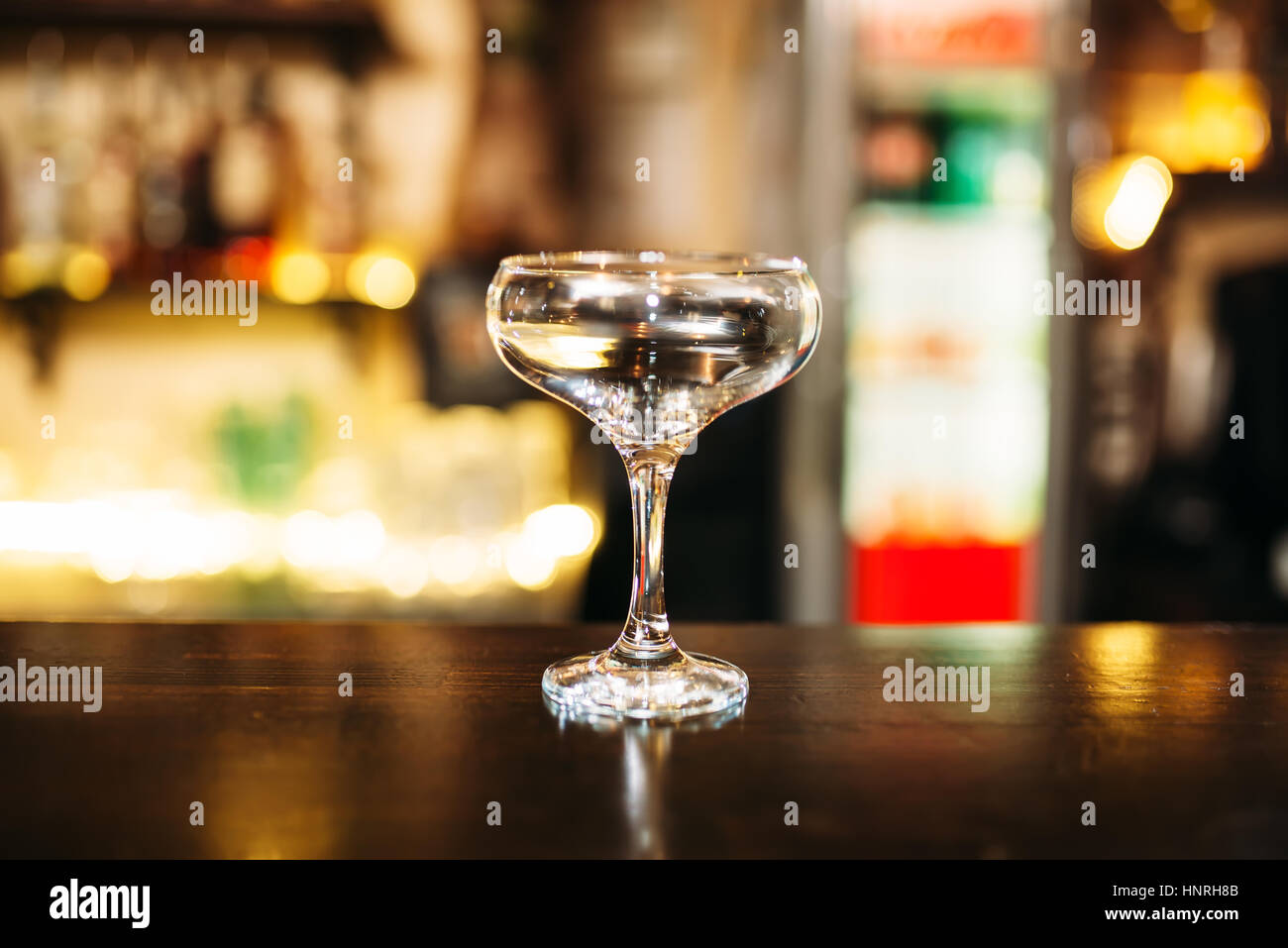 Transparent beverage in glass on wooden bar counter Stock Photo - Alamy