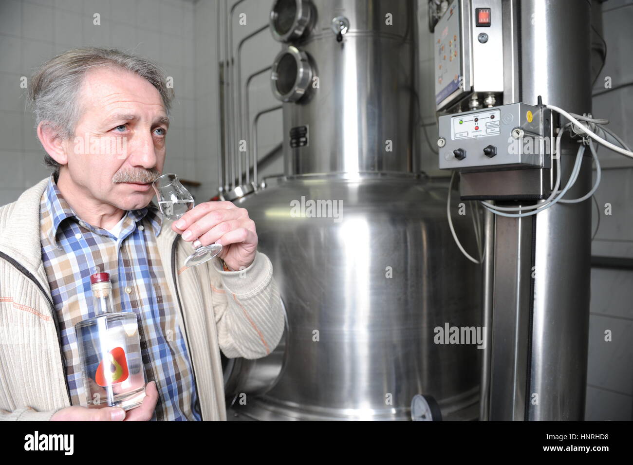 Worms, Germany - March 24, 2009: Man tasting his self made pear ...