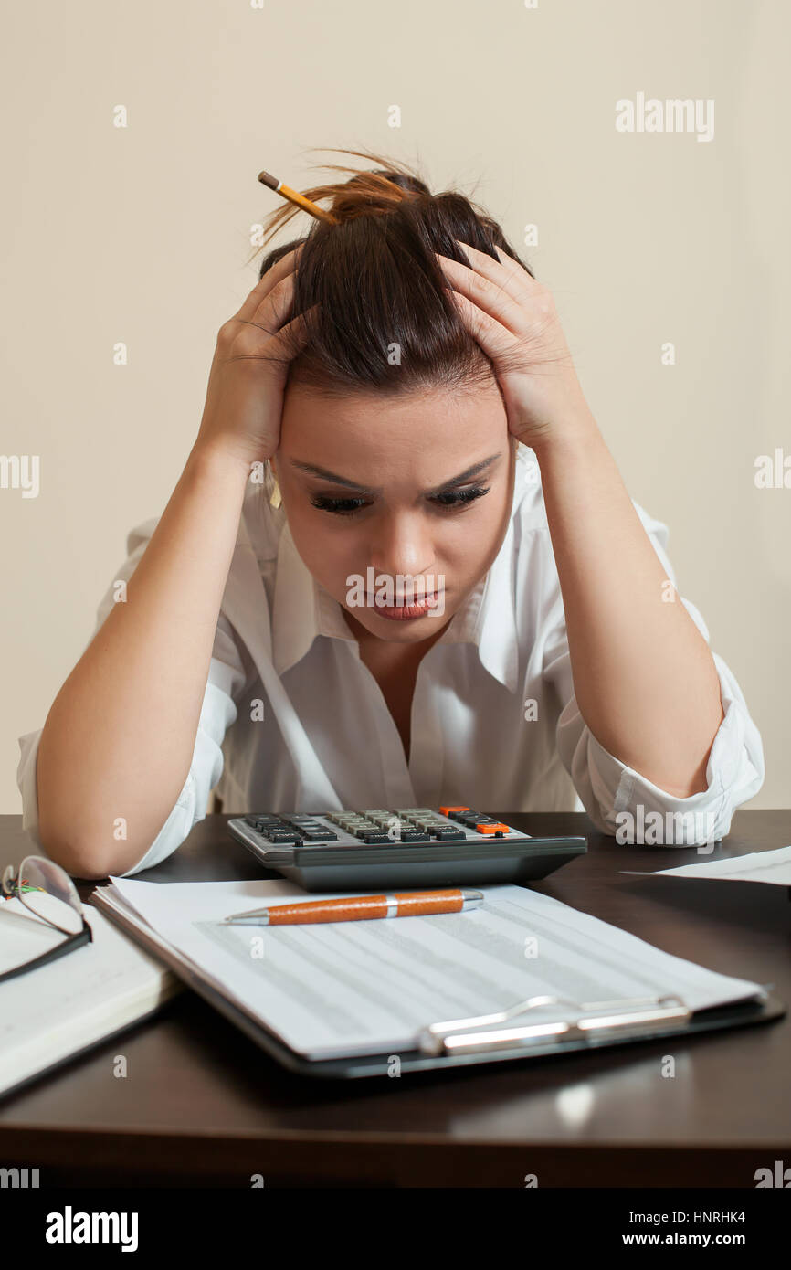 Frightened accountant looks at the accounting balance sheet Stock Photo ...