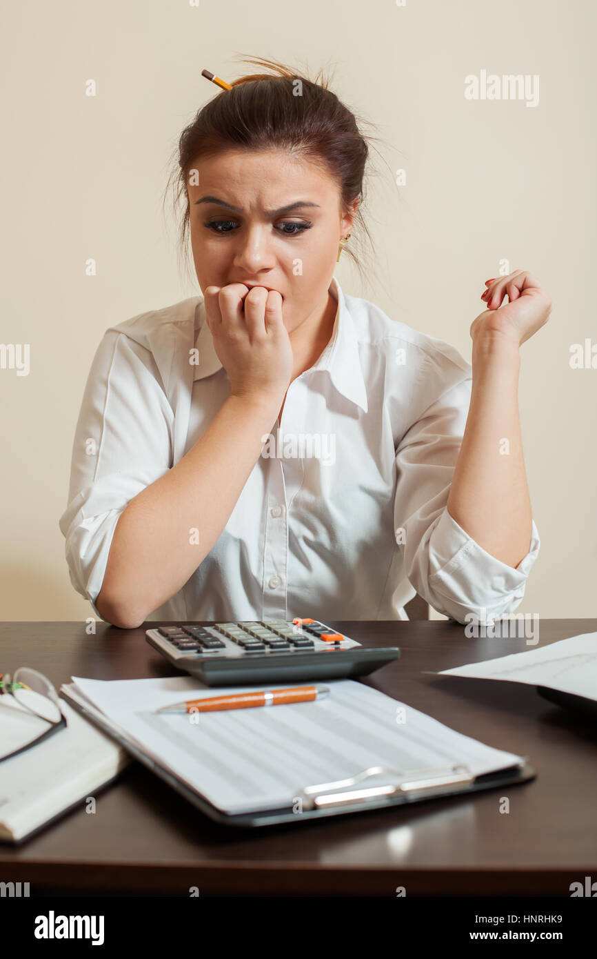 Frightened accountant looks at the accounting balance sheet Stock Photo ...