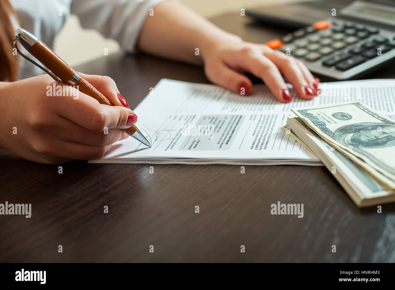 Woman bookkeeper signs accounting documents. Businesswoman concept ...