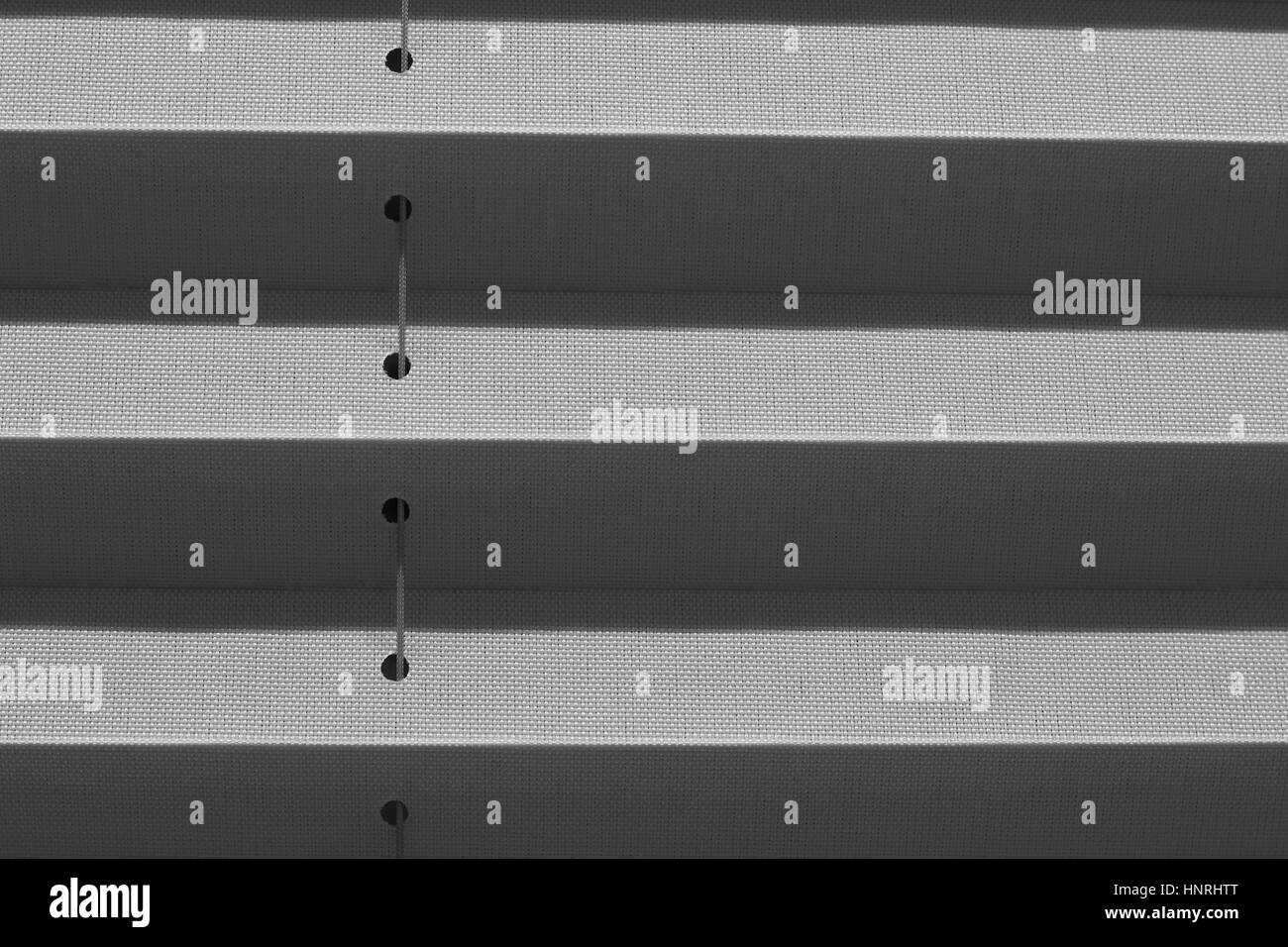 Window gray pleated blind close up with details in home interior ...