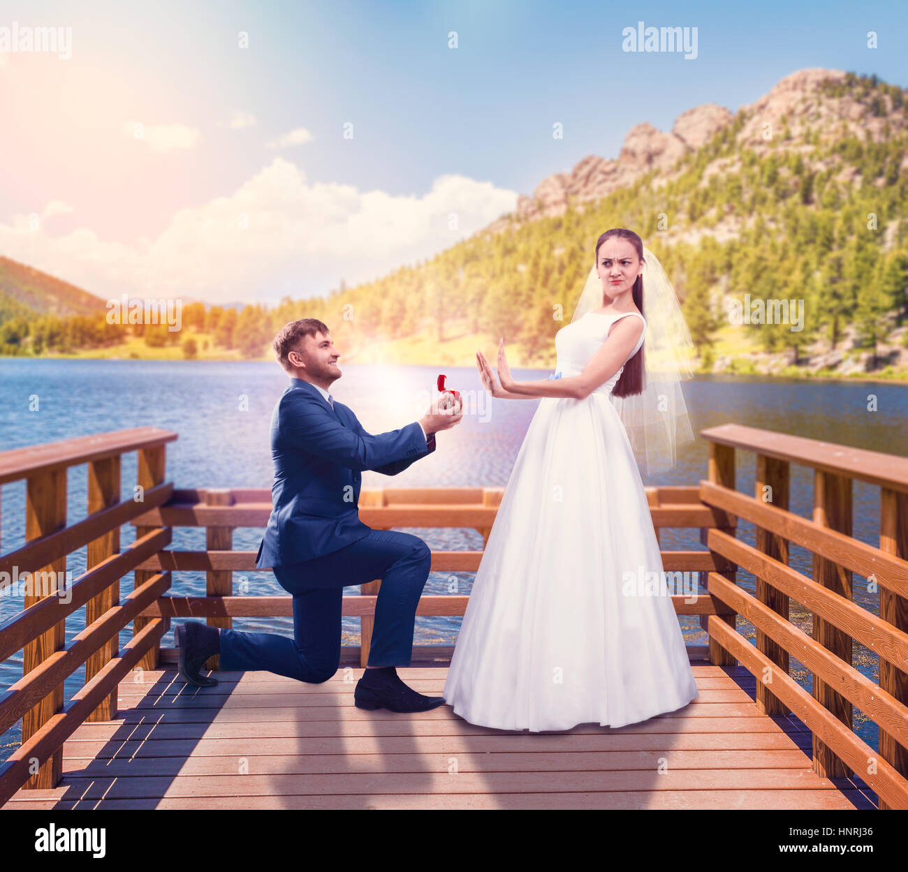 Groom makes a proposal of marriage on the pier, the lake on the ...