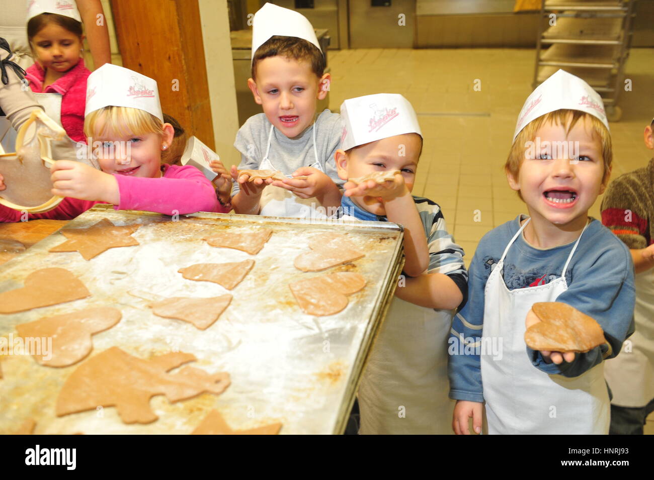 Hamburg, Germany - November 24, 2009: Kindergarten kids baking ...