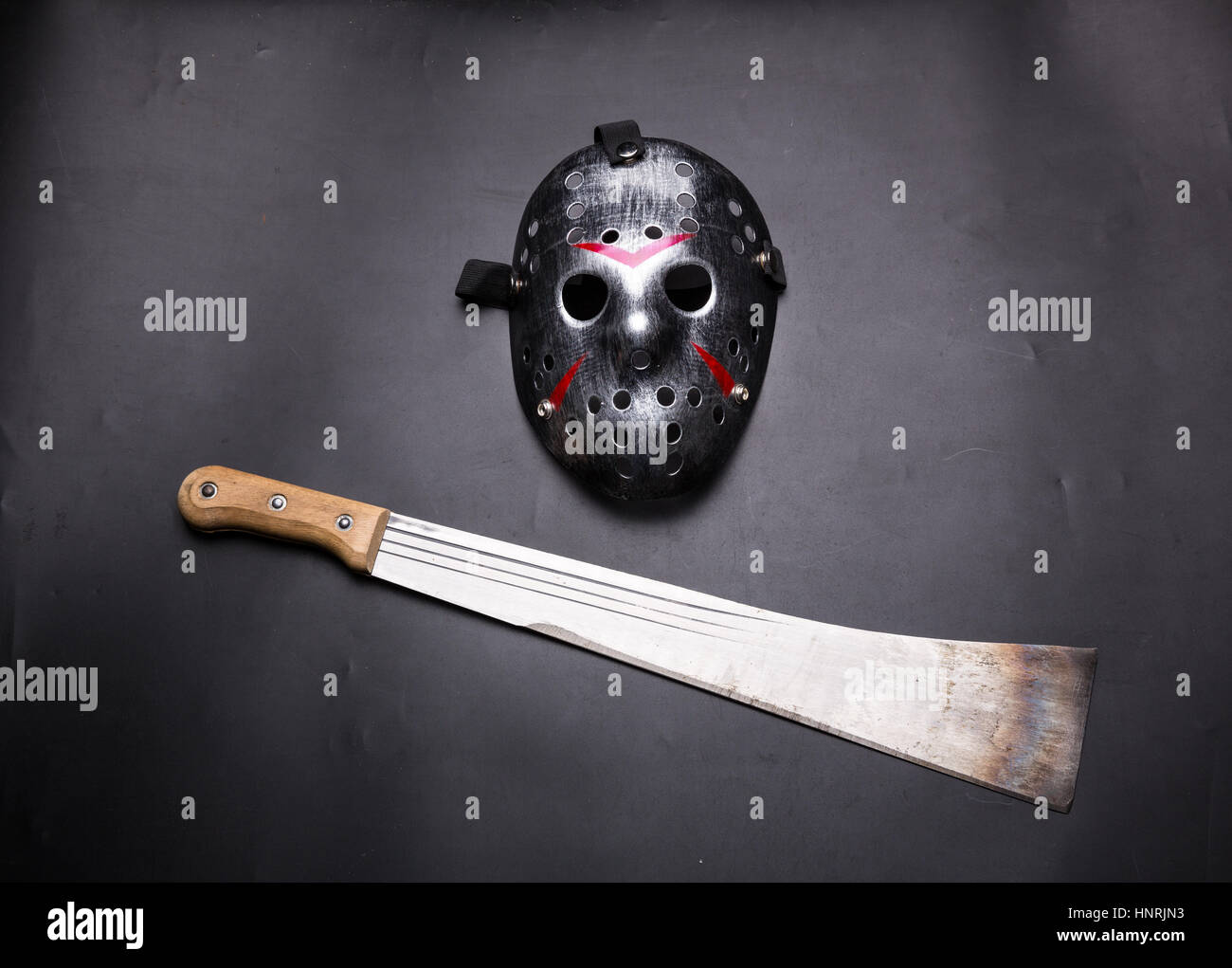 Murderer hockey mask with bloody stripes and machete isolated on black ...