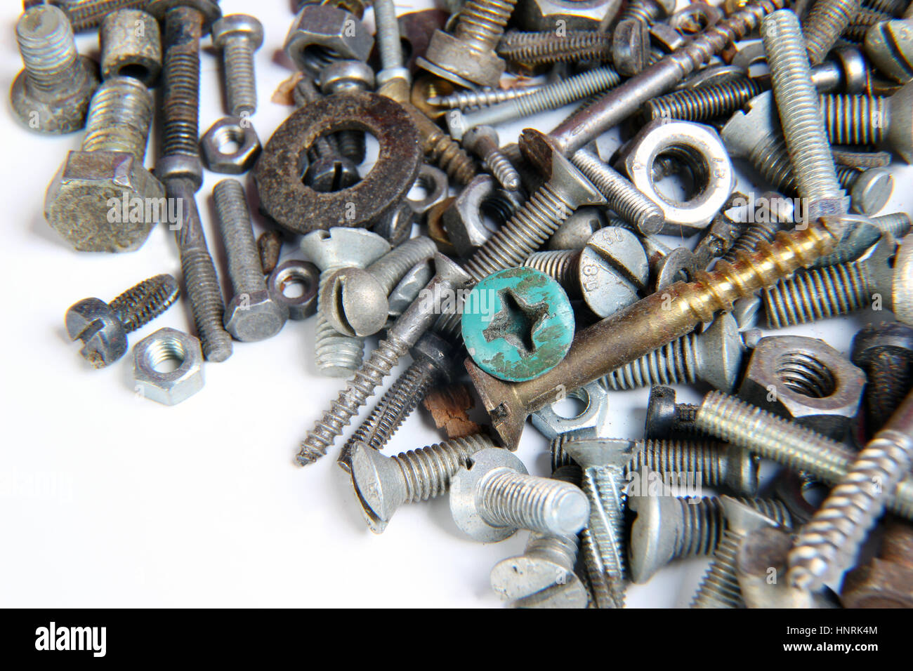 A lot of screws and nuts on a white background Stock Photo - Alamy