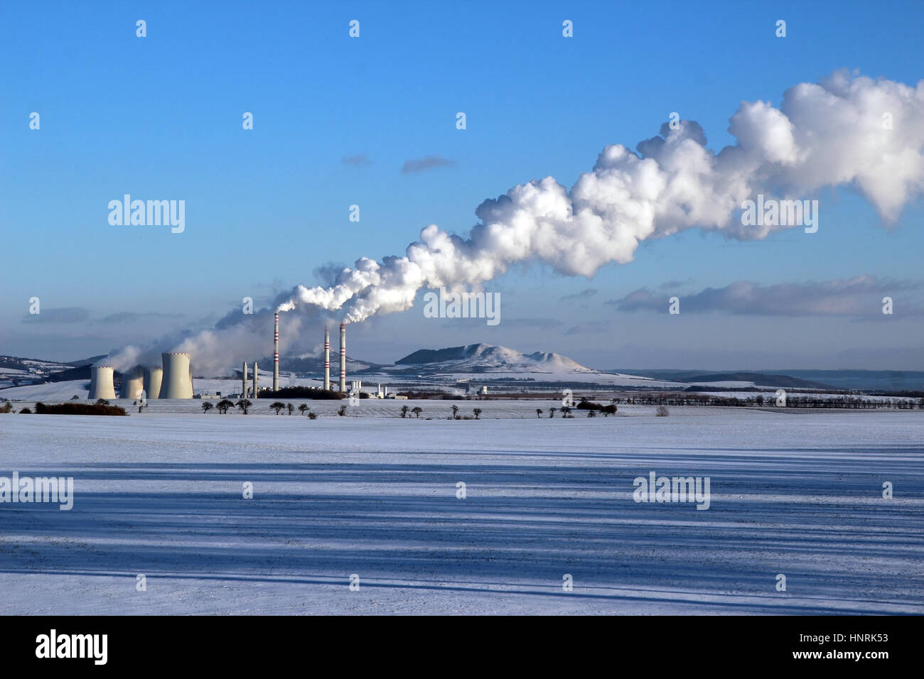 snowy landscape with steaming coal power plant Stock Photo - Alamy