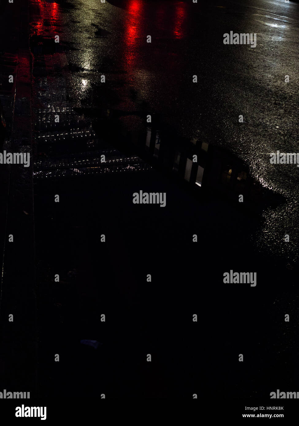Car and traffic lights reflection in puddle in London Stock Photo - Alamy