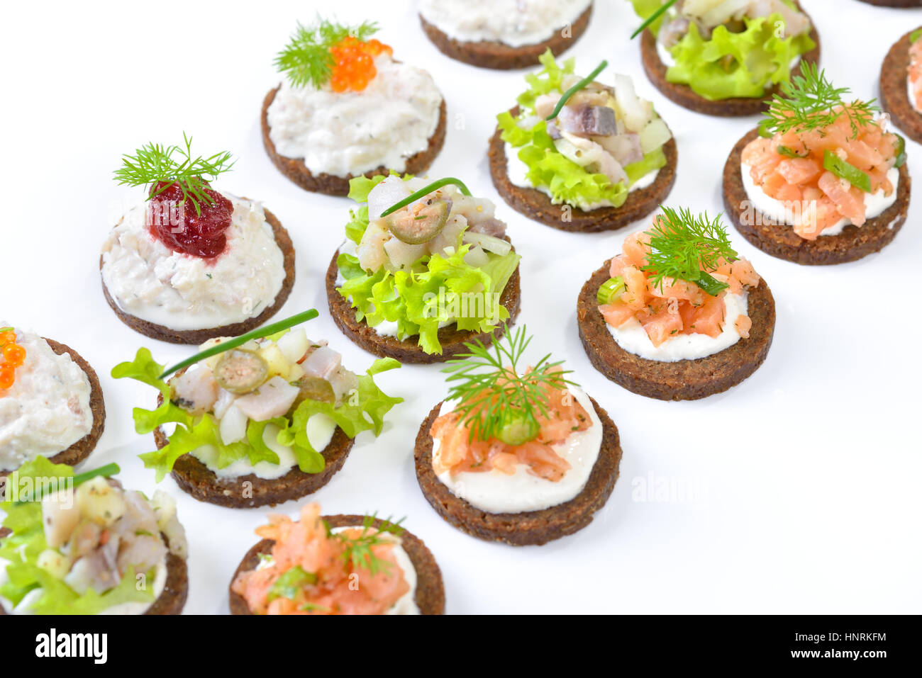 Tasty fish finger food with smoked salmon tartar, trout mousse with ...