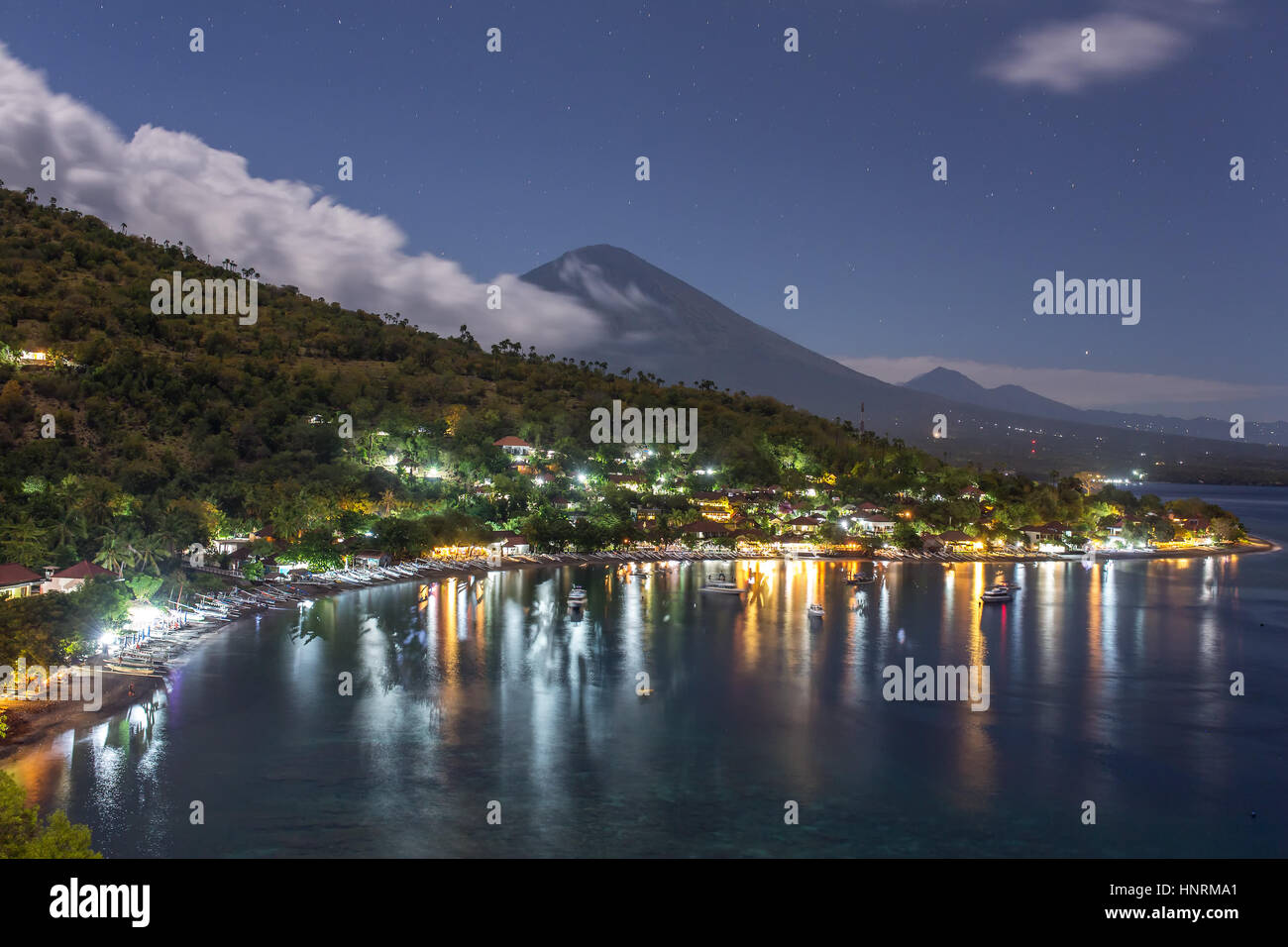Jemeluk Beach and beautiful Agung volcano with a stars sky at night ...