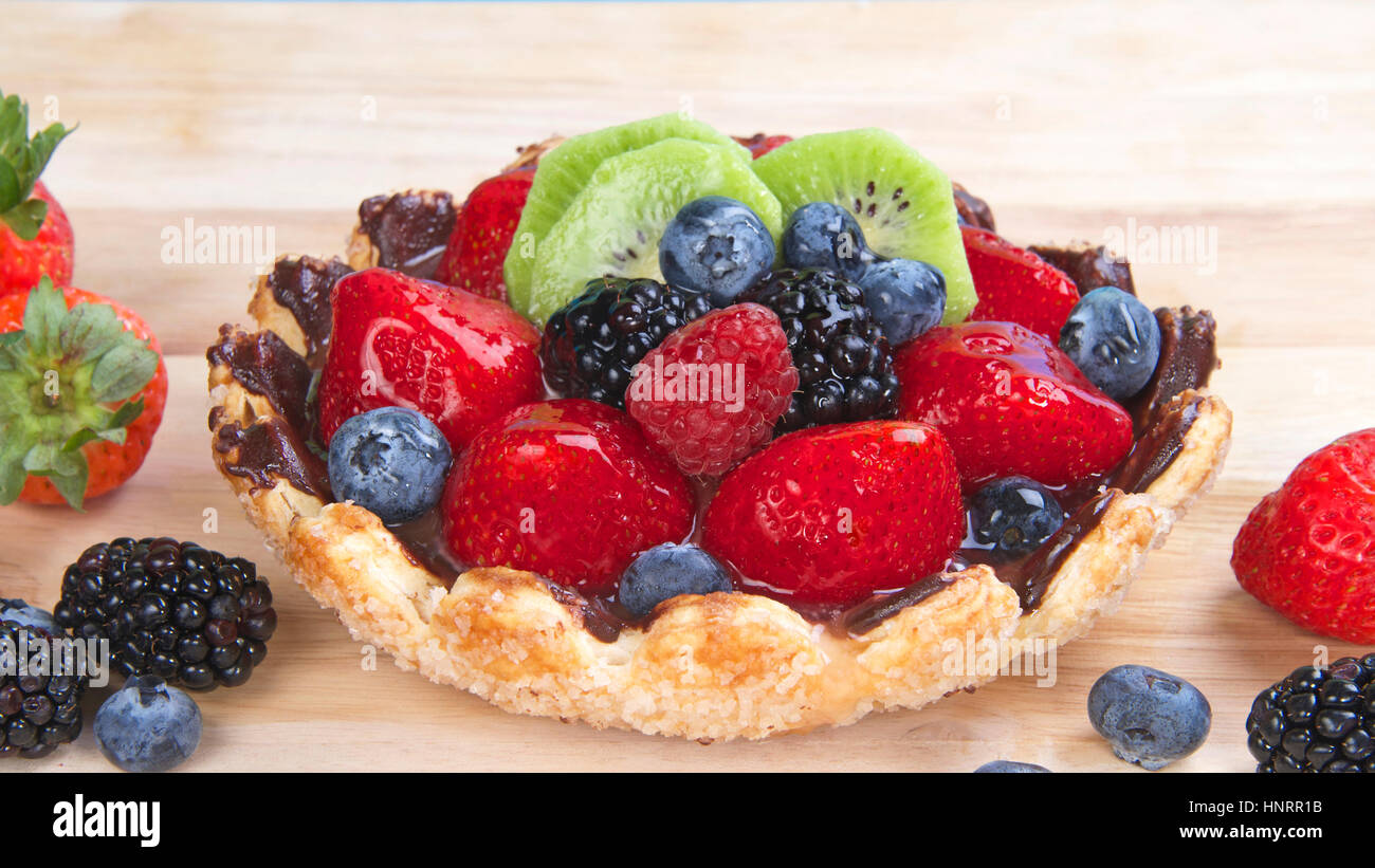 Fresh fruit tart with flower shaped pie crust sprinkled with sugar ...