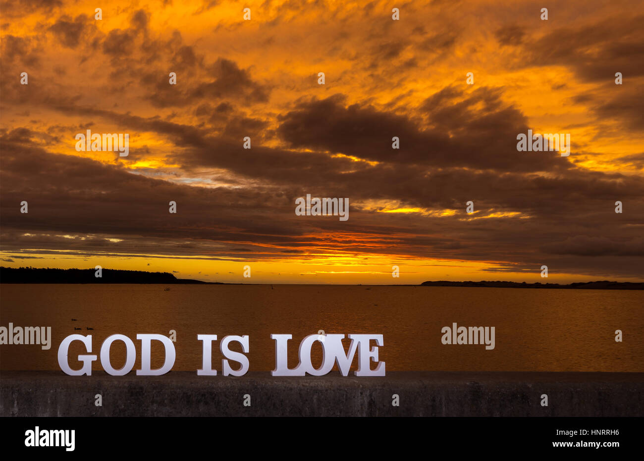 God is Love with a wonderful golden Sunset Stock Photo - Alamy