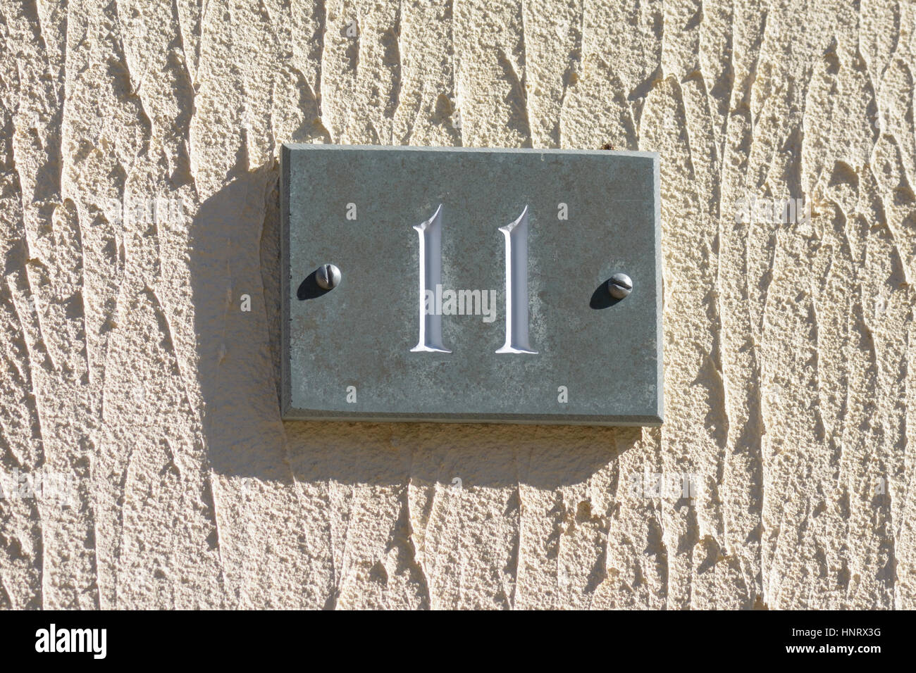 House number 11 sign on wall Stock Photo - Alamy