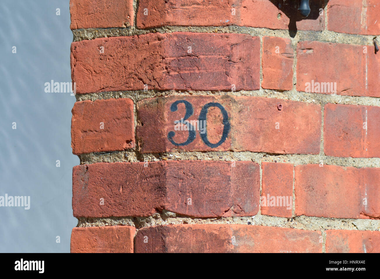 House number 30 sign on wall Stock Photo - Alamy