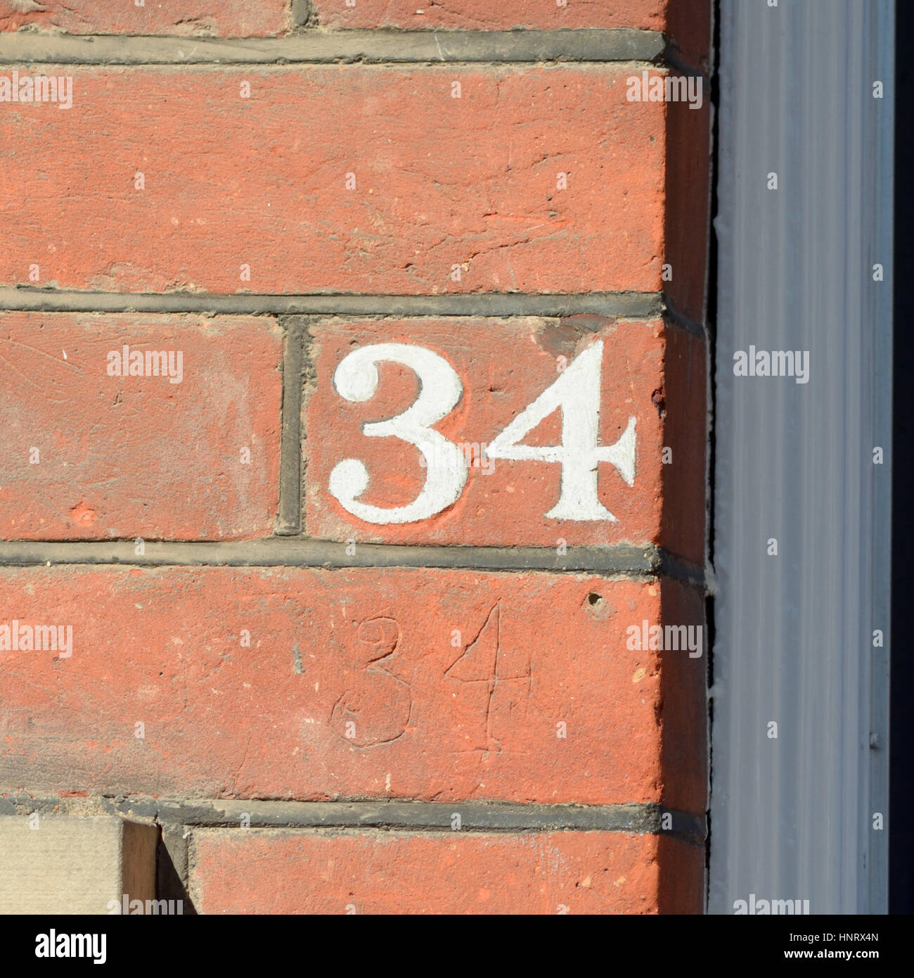 House number 34 sign on wall Stock Photo - Alamy