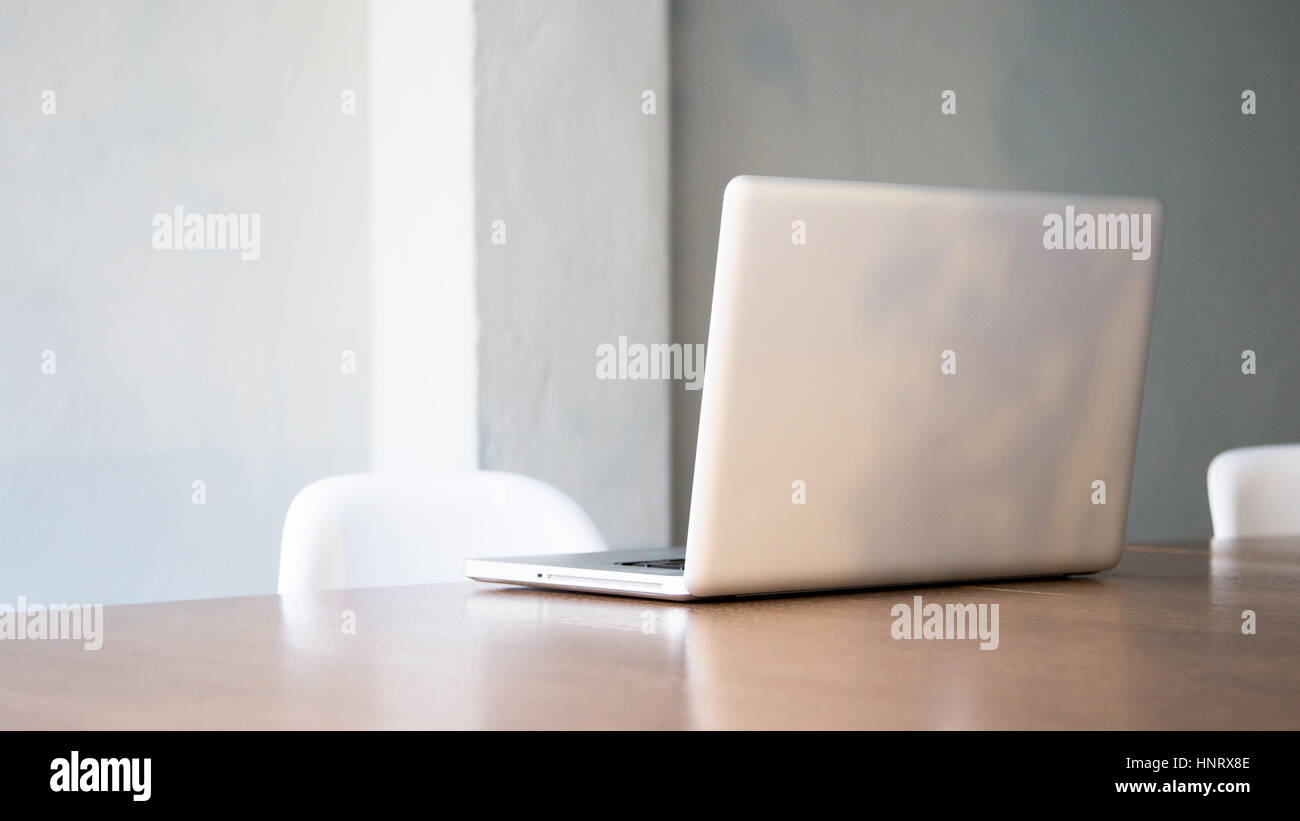 Laptop computer on office desk Stock Photo - Alamy