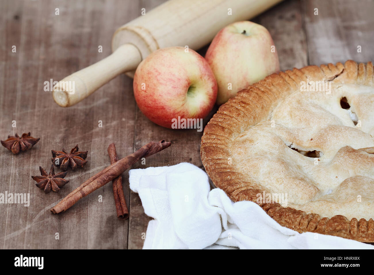 Homemade apple pie dessert with rolling pins and ingredients over a ...