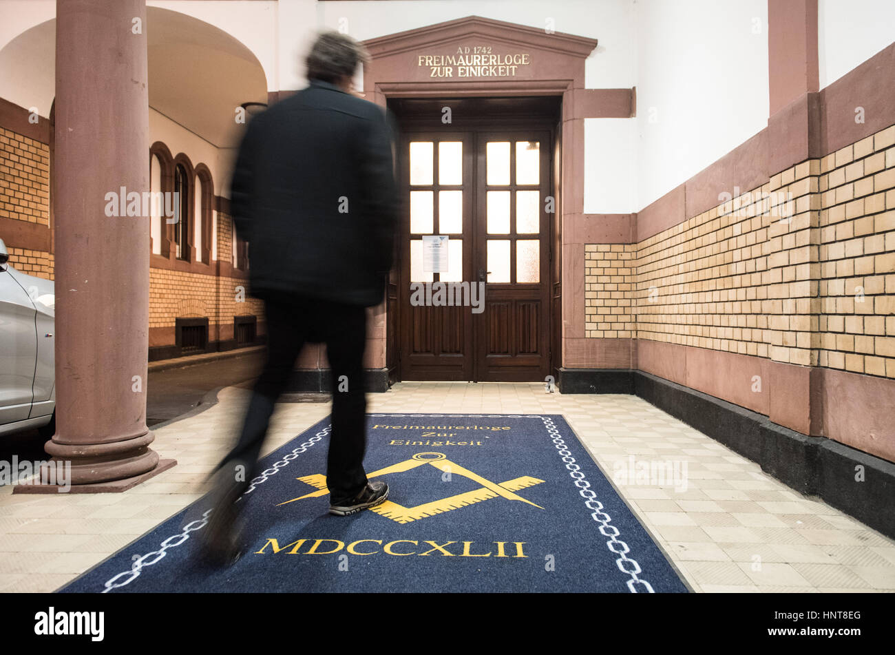 A man walks on a carpet with freemason symbols at the lodge in ...