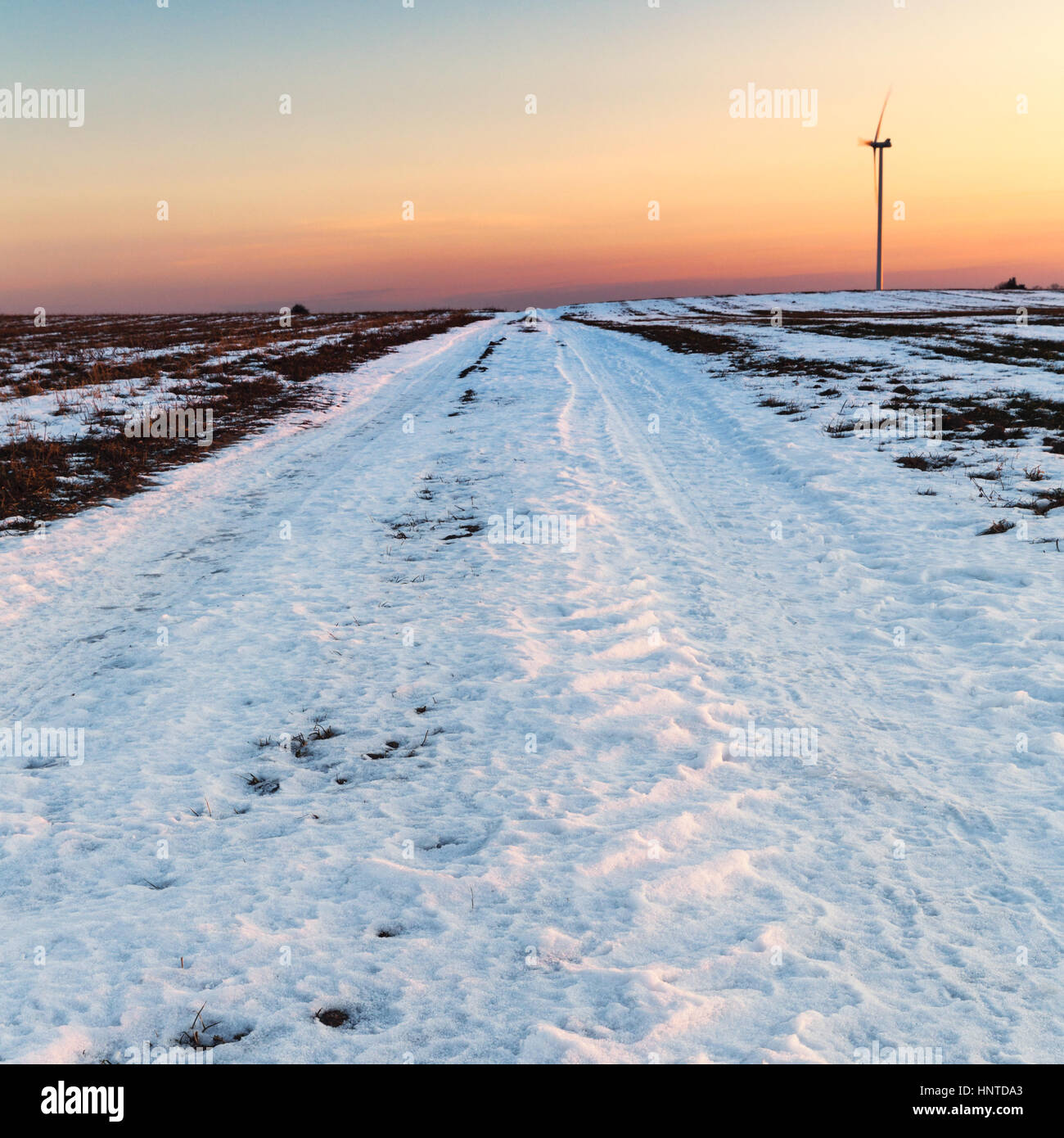Wintry Field in Snow with Single Wind Turbine in Background Stock Photo ...