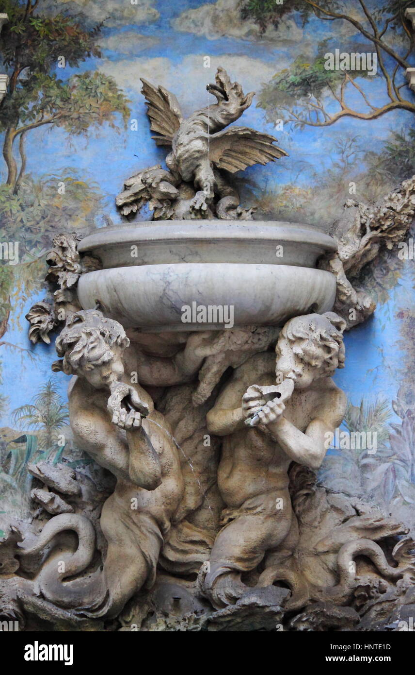 Baroque fountain with two satyrs spitting water Stock Photo - Alamy