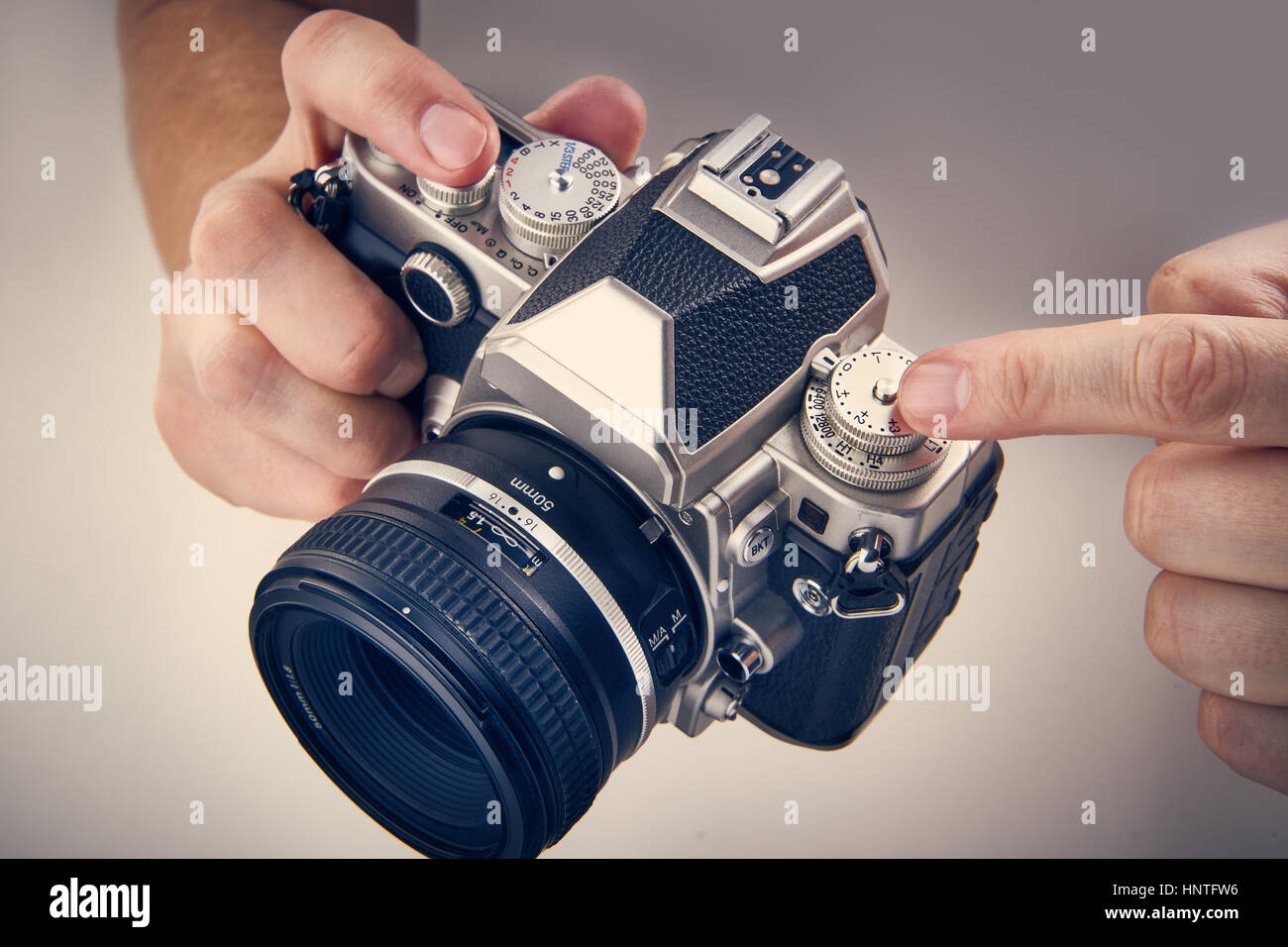 Retro SLR camera in the hands of the photographer close-up Stock Photo ...