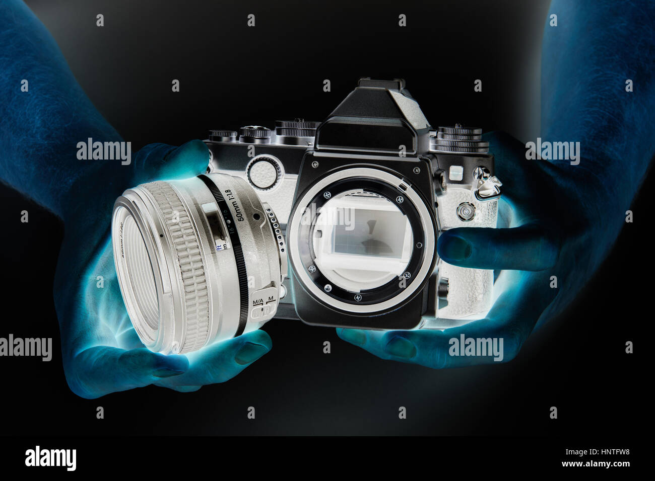 Negative photo of SLR camera in the hands of the photographer closeup ...