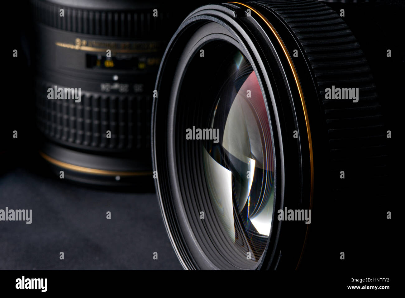 Photo lens side view on blurred object background Stock Photo - Alamy