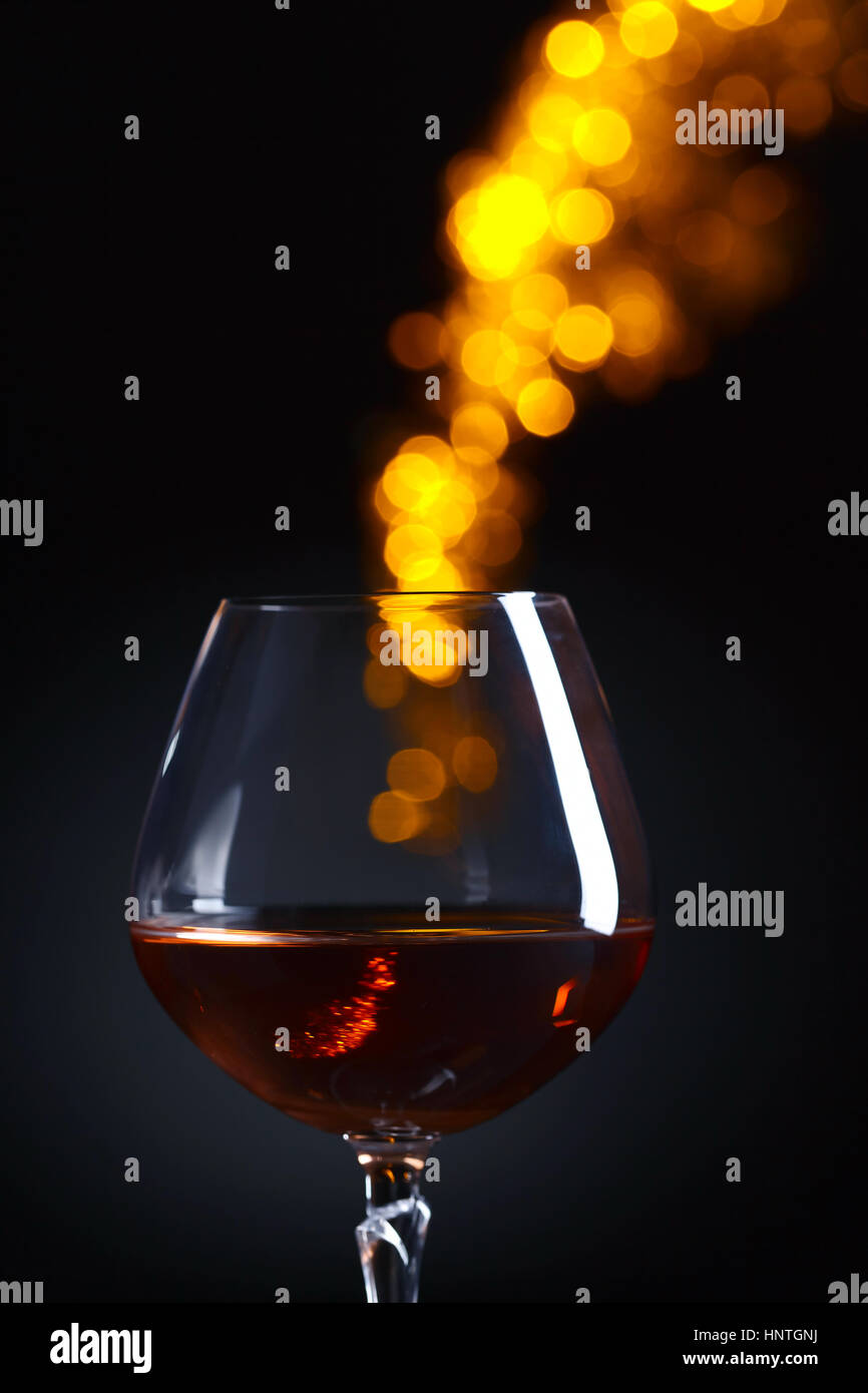 Snifter of brandy on a dark background Stock Photo - Alamy